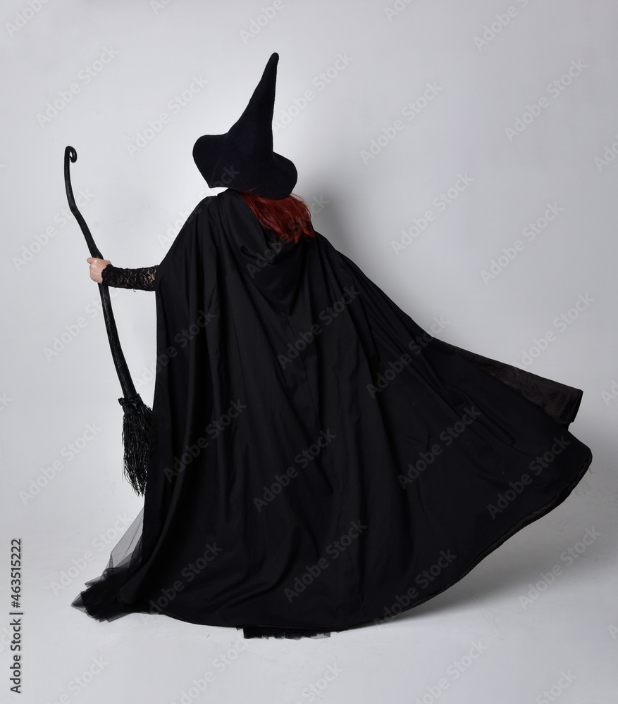 Full length portrait of dark haired woman wearing black victorian witch ...