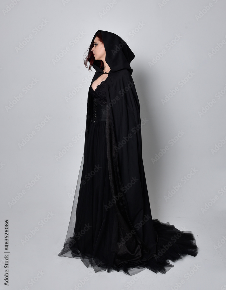 Full length portrait of dark haired woman wearing black victorian witch ...