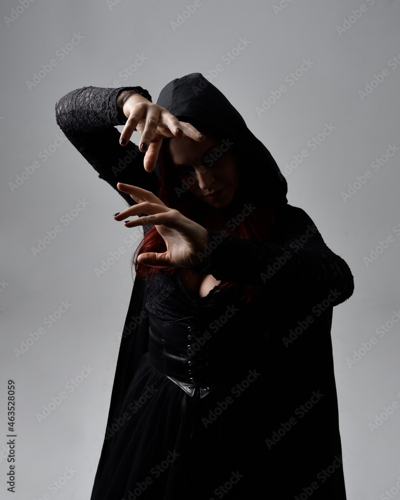 close up portrait of red haired woman wearing black victorian witch ...