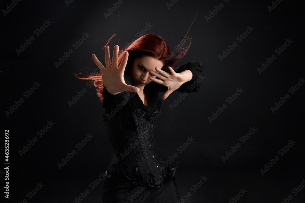 close up portrait of red haired woman wearing black victorian witch ...