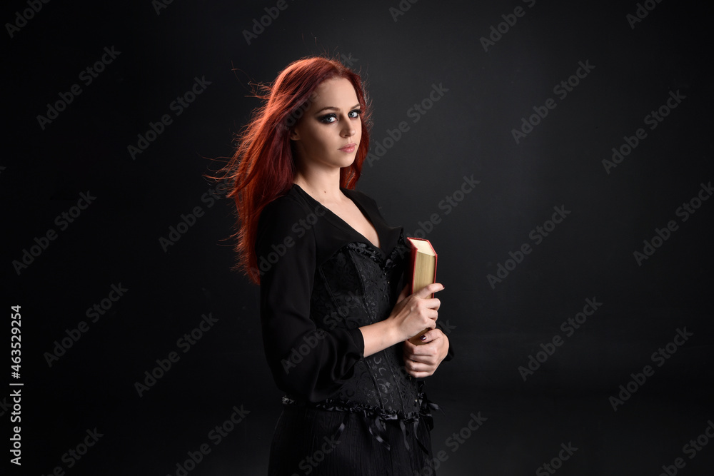close up portrait of red haired woman wearing black victorian witch ...