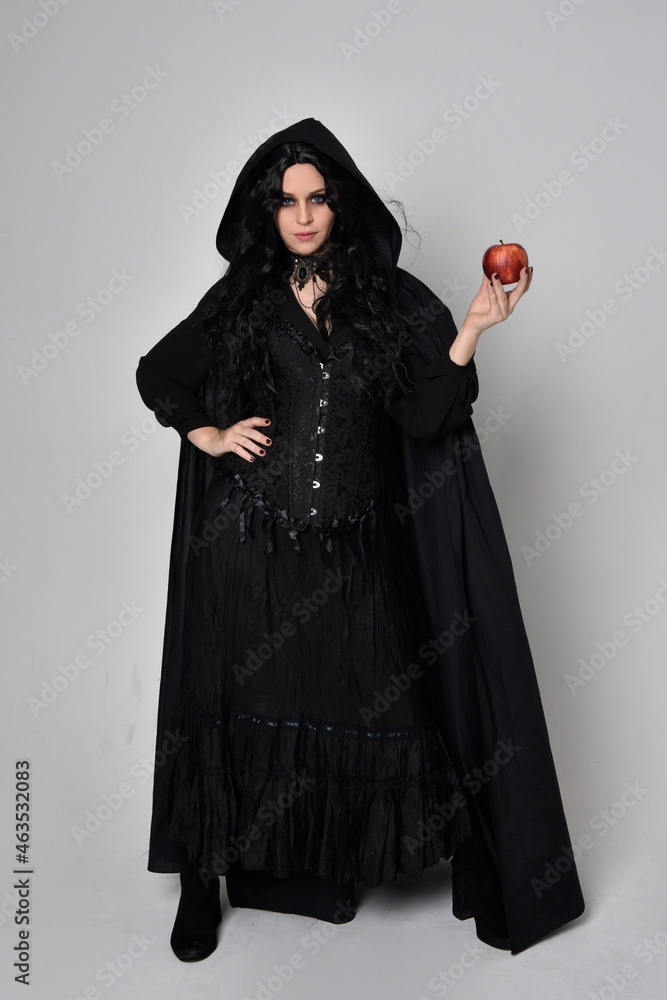 Full length portrait of dark haired woman wearing black victorian witch ...