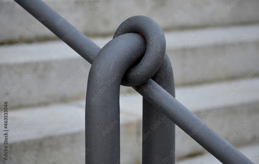 wide stone staircase with railings in the middle of the ramp. forged ...