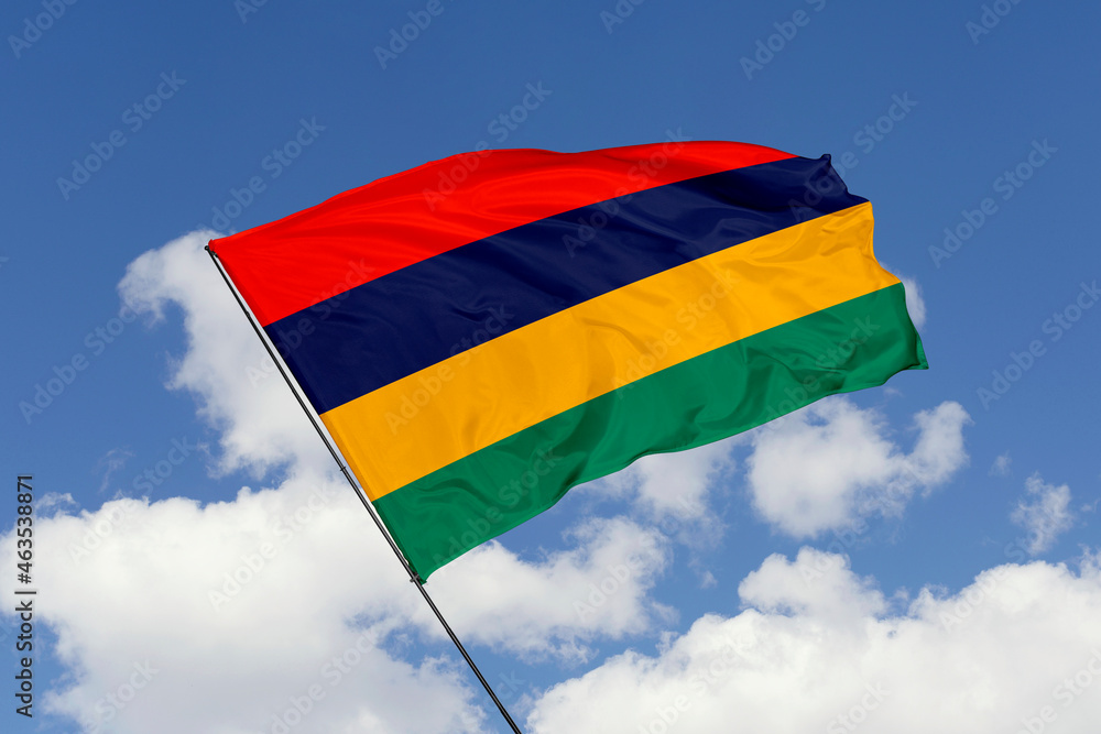 Mauritius flag isolated on the blue sky background. close up waving ...