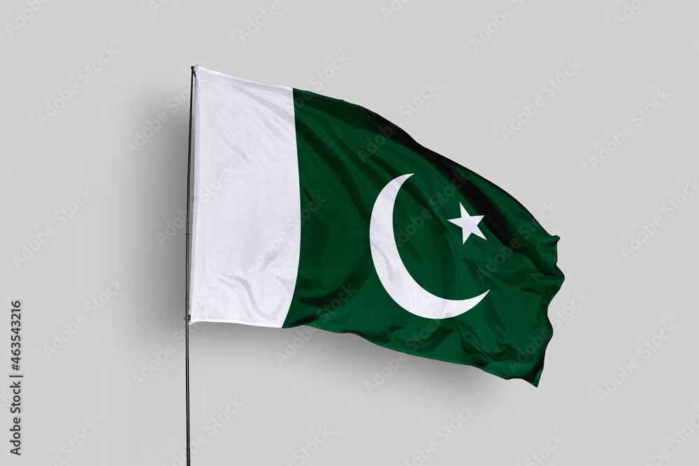 Pakistan flag isolated on the blue sky background. close up waving flag ...