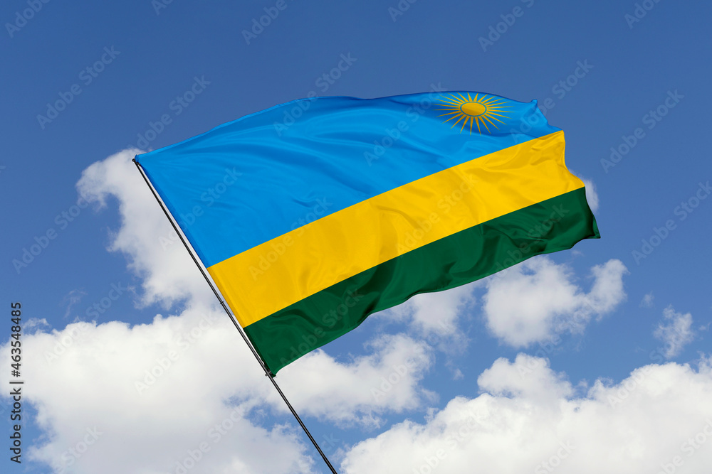 Rwanda flag isolated on the blue sky background. close up waving flag ...
