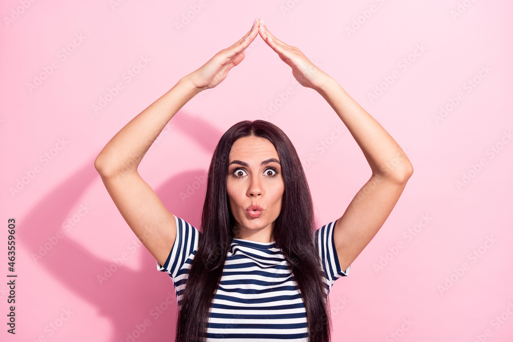 Portrait of attractive funny amazed woman showing roof over head pout ...