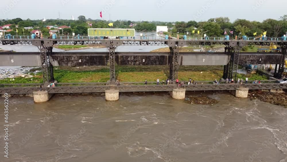 Aerial view of Rama 6 Dam (Phra Narai Gate) with powerful of water ...