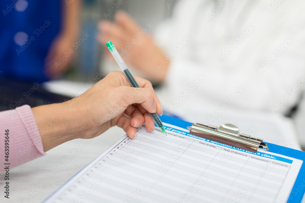 At the doctor's office, the patient completes a declaration on COVID-19 ...