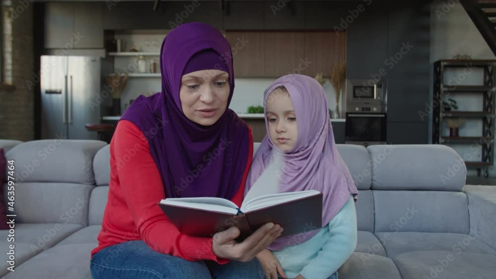 Affectionate charming muslim mother with adorable elementary age ...