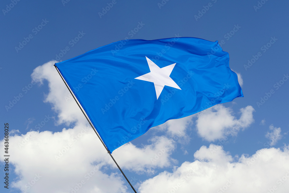 Somalia flag isolated on the blue sky background. close up waving flag ...
