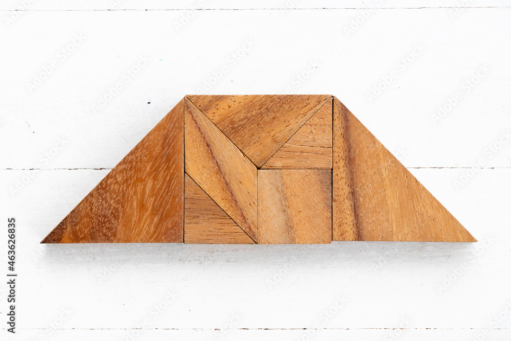 Wood tangram puzzle in trapezium shape on white wood background Stock ...