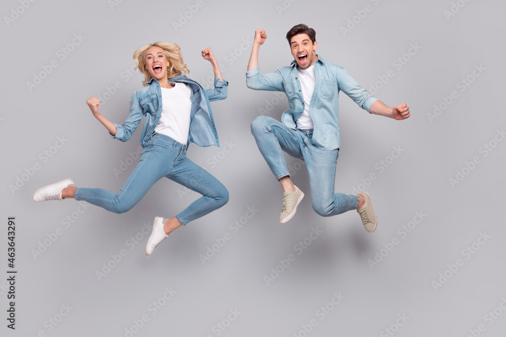Full size photo of hooray couple jump wear jeans shirt shoes isolated ...