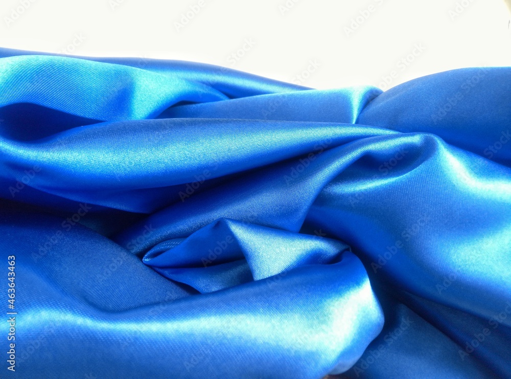 blue satin fabric. mound of wrinkled and crumpled blue satin fabric on ...