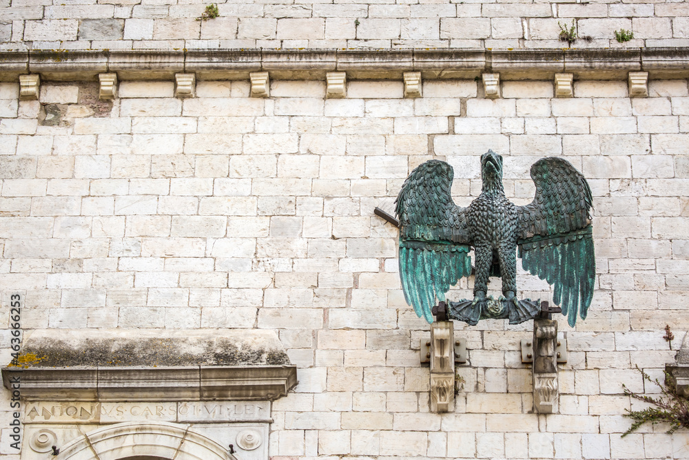Statue of an eagle on the facade of the medieval sign in Italy ...