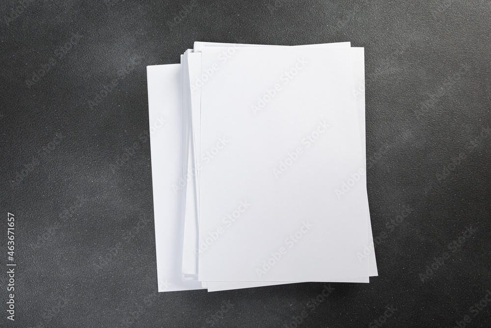 White business card sheet of paper a4 stack on a dark table. Clean ...