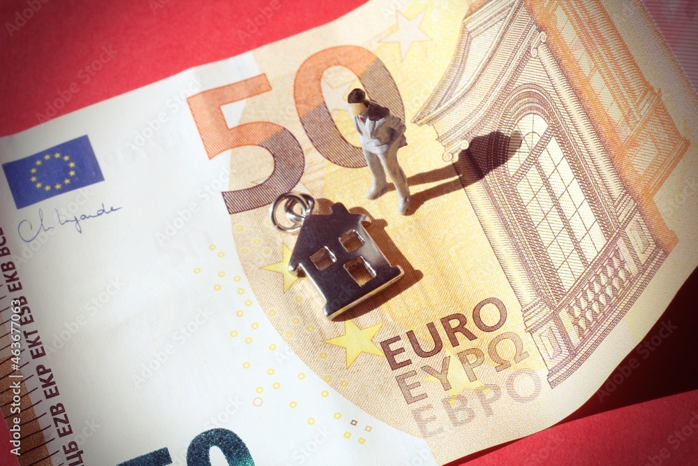 Miniature business man inside a 50 euros banknote and a symbol of a ...