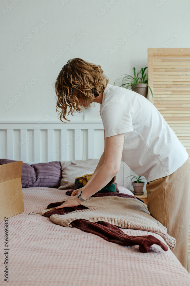 Woman packing wear in box Stock Photo | Adobe Stock