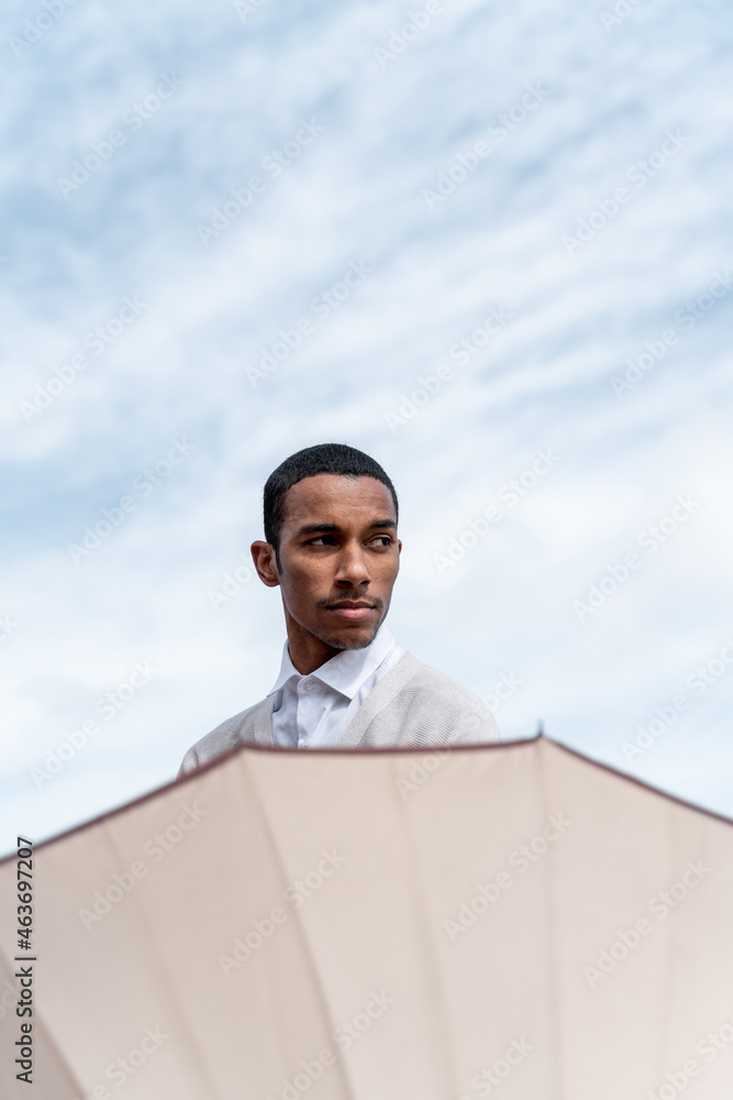 Stylish man posing with an open parasol outdoor Stock Photo | Adobe Stock