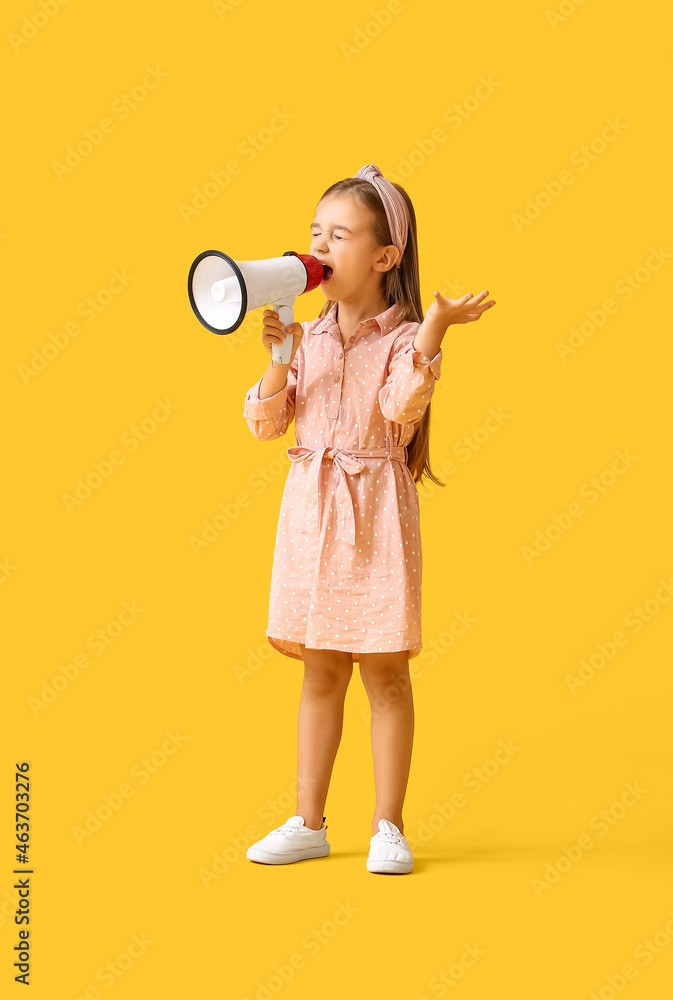 Angry little girl shouting into megaphone on yellow background Stock ...
