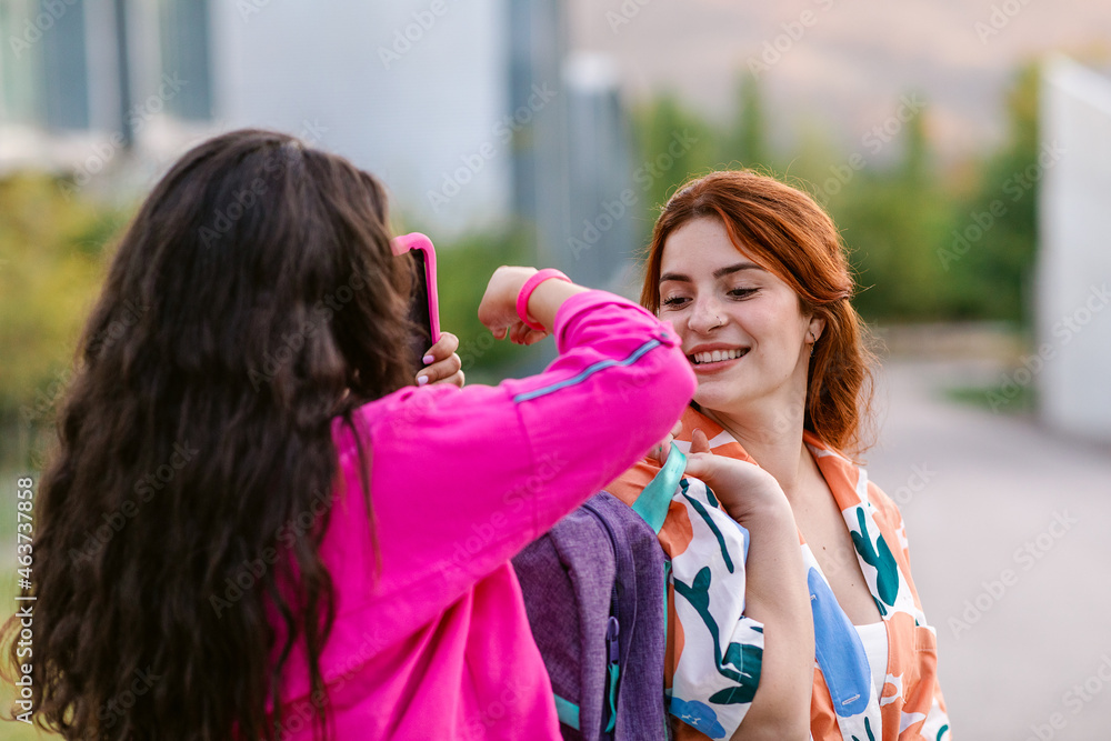 Friend helping each other with backpack Stock Photo | Adobe Stock
