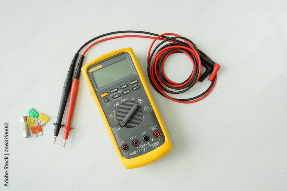 Yellow Digital multimeter with probes on white background , A ...