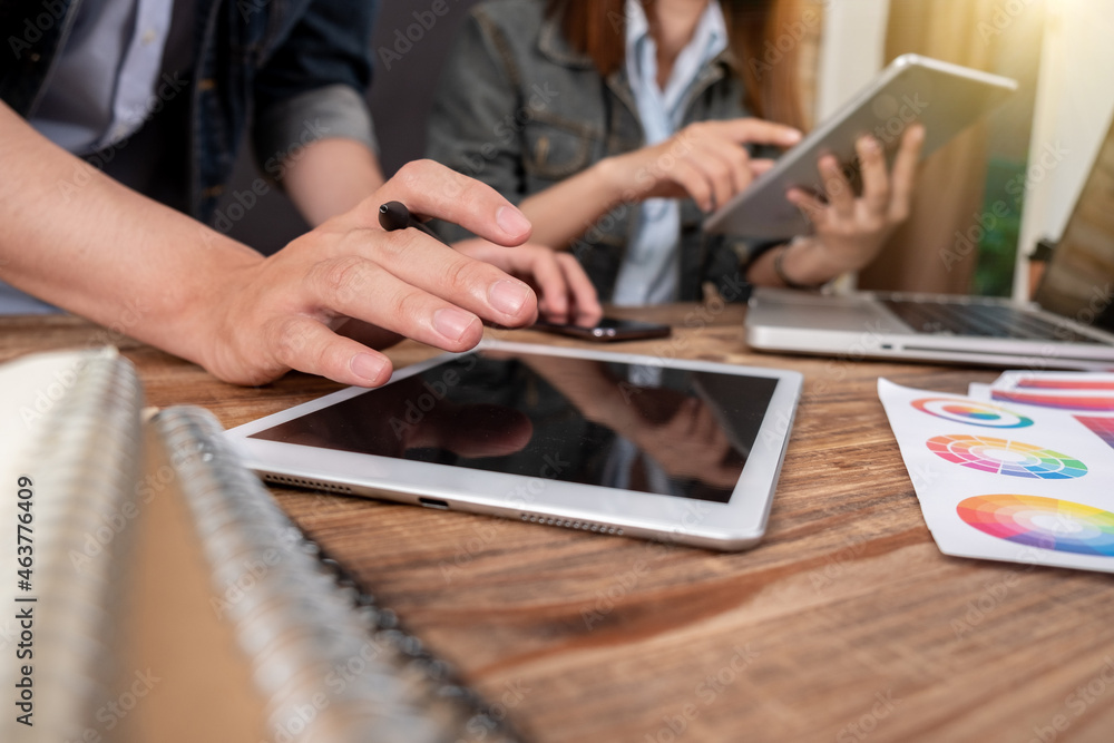 Designer Young asian using graphics tablet while working with computer ...