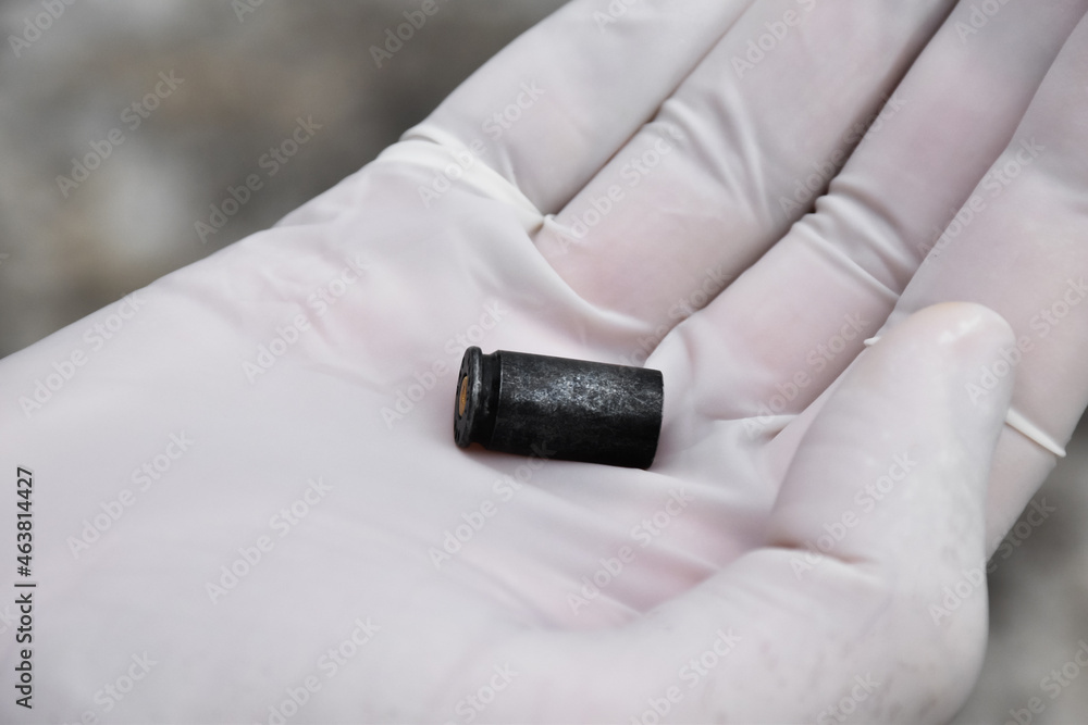 Pistol's bullet shells in palm of investigator or police officer ...