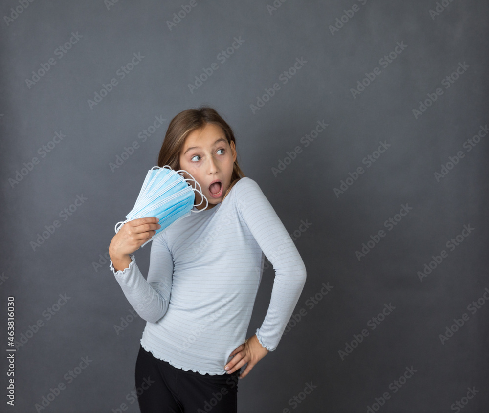 Portrait of a young scared girl with open mouth with fan made of ...