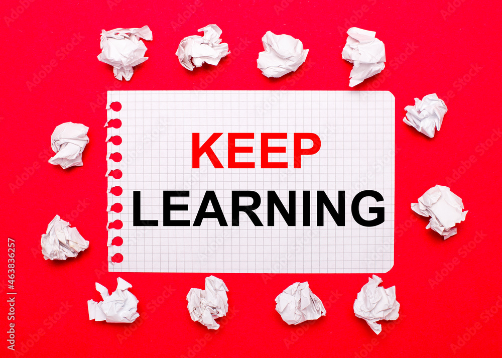 On a bright red background, white crumpled sheets of paper and a sheet ...