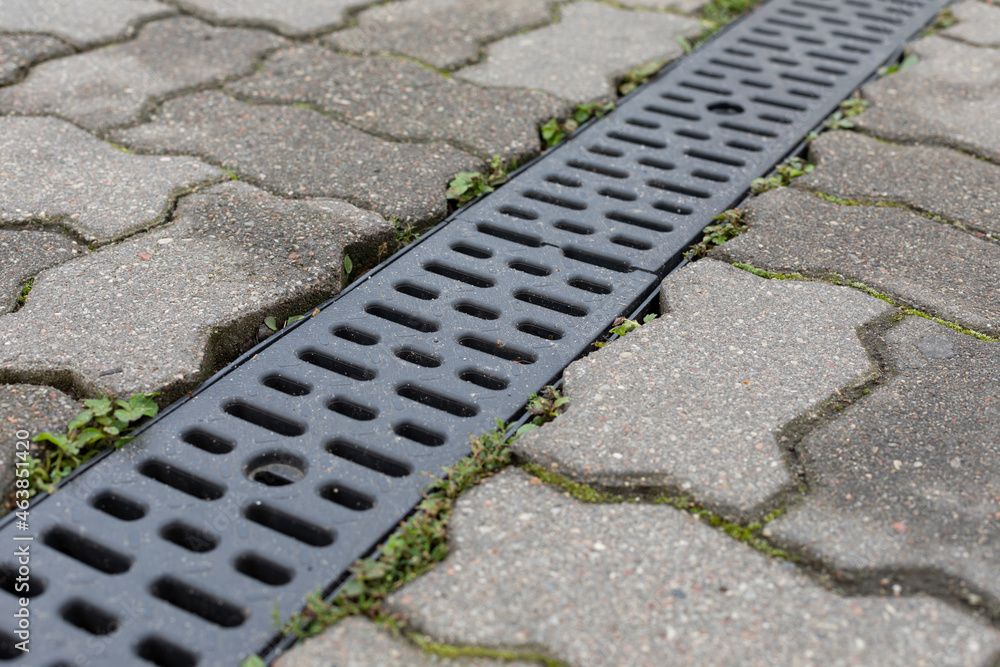Grating of drainage system rainwater in the park at the sidewalk from a ...