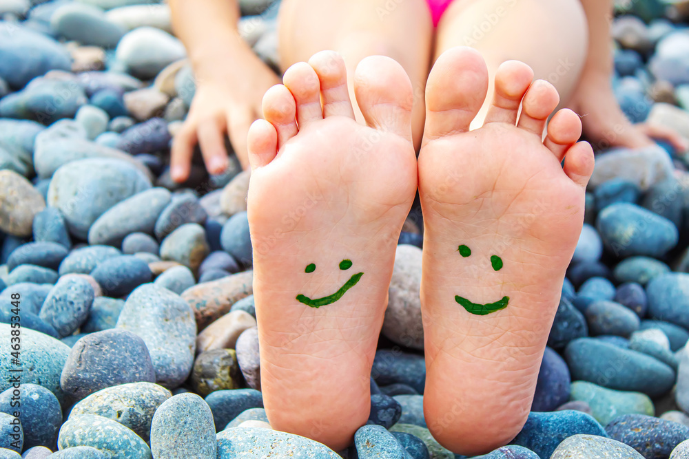 Child feet painted with paints on the sea. Selective focus. Stock Photo ...