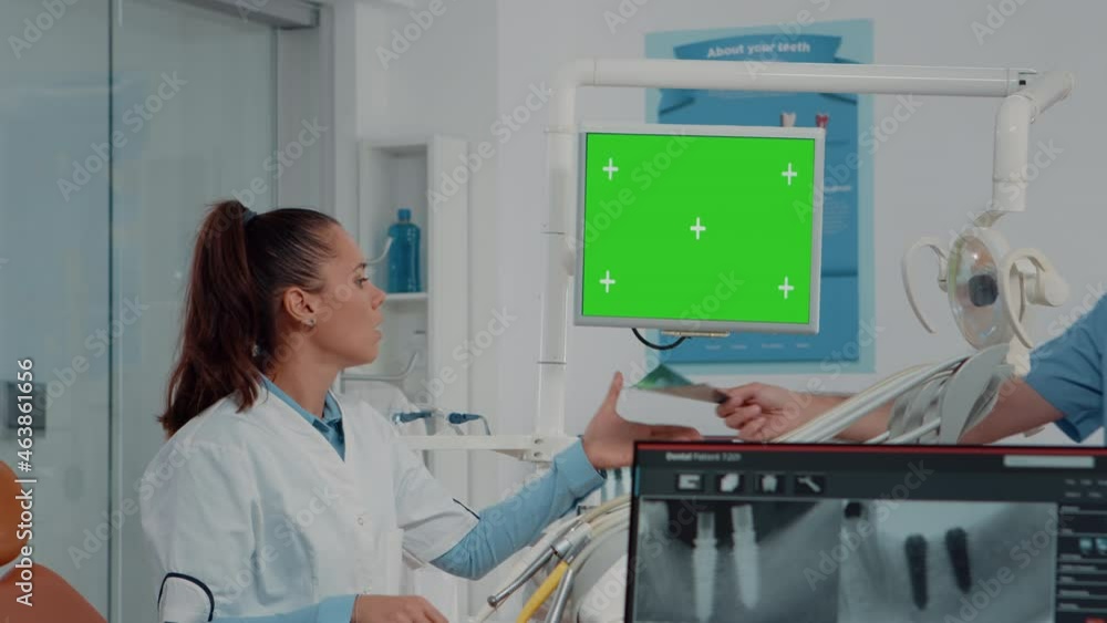 Woman working as dentist with green screen and x ray scan for teethcare ...