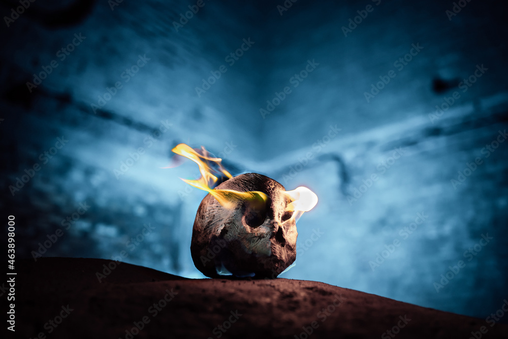 a burning human skull. flames from the eye sockets of the skull. a fake ...