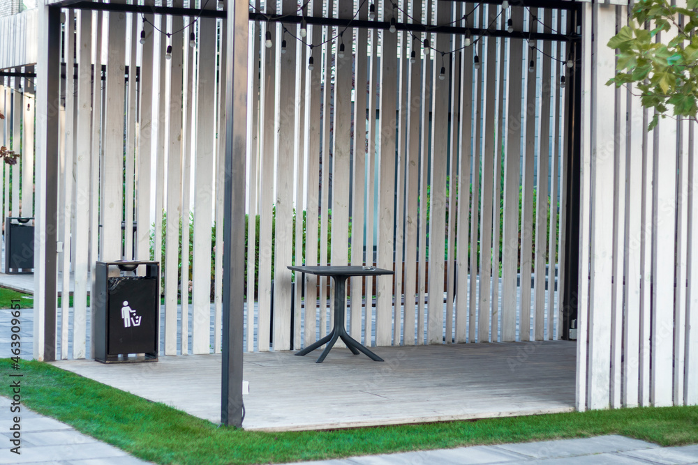 Modern smoking zone outside. business building, wooden gazebo with ...