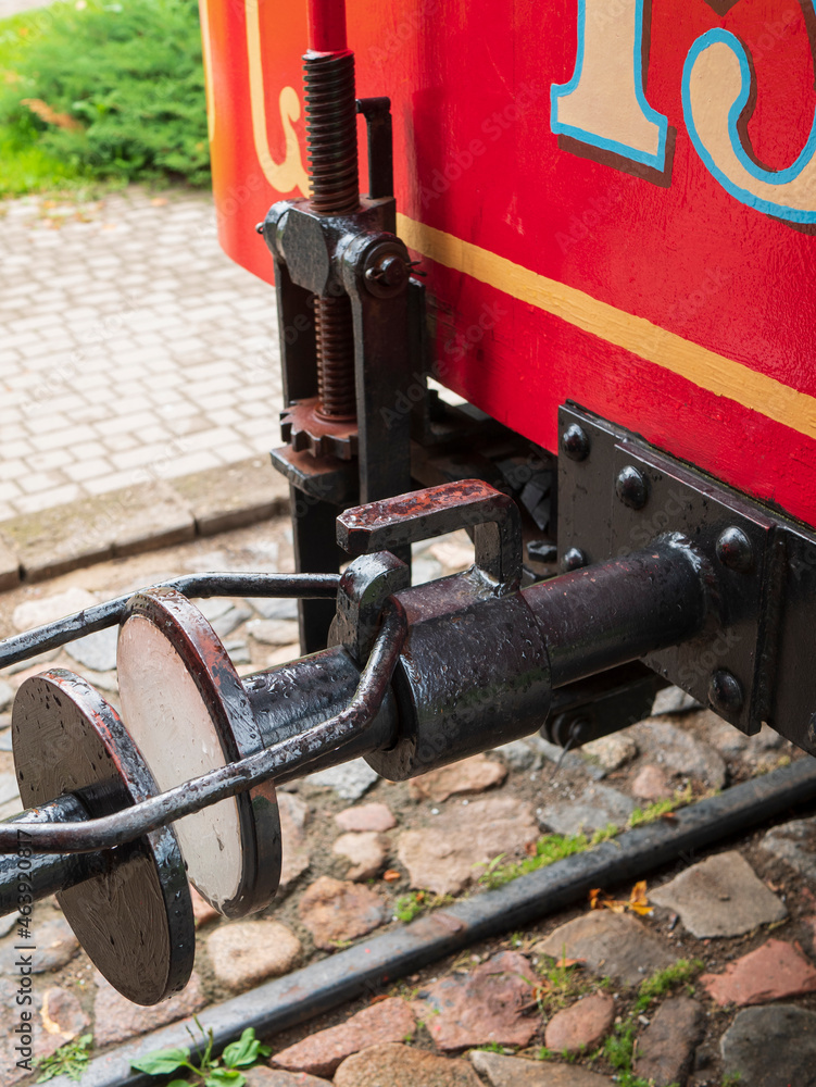 Coupling connects hooks on the adjoining red wagons. Type of connection ...
