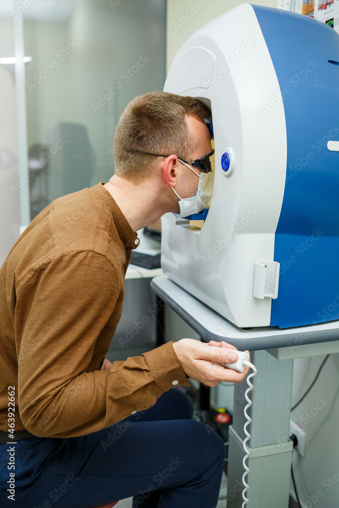 Professional medical equipment scanning the patient's eyes. The device ...