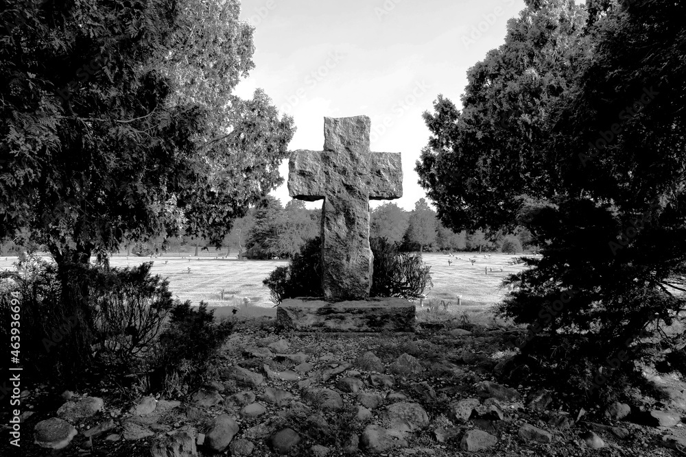 cemetery scene with big stone cross grave tombstone in black and white ...