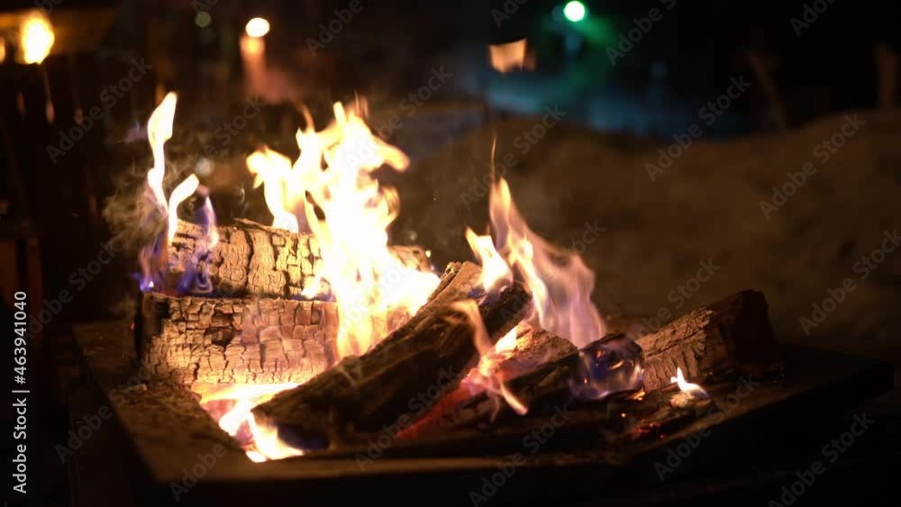 SEAMLESS LOOP VIDEO. Campfire in firepit outdoors in winter with snow ...