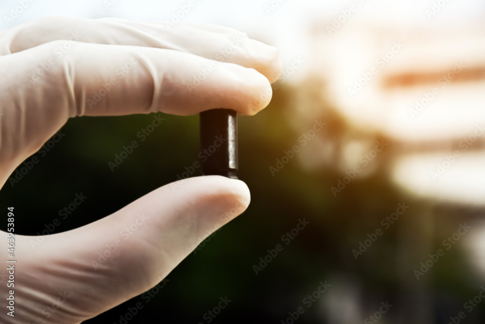 Forensic officers holds physical evidence which is the bullet shell up ...