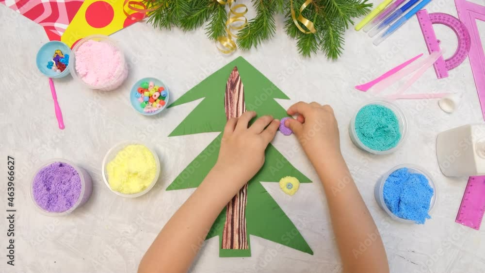 Child makes a greeting card Christmas paper and foam plasticine craft ...
