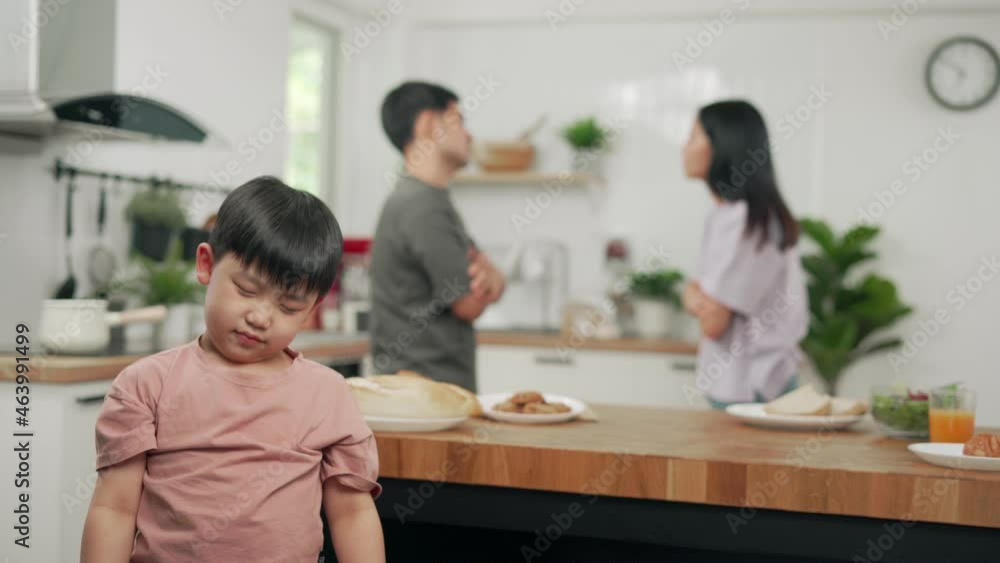 problem in family. Asian boy sitting and use hands close ears feel ...