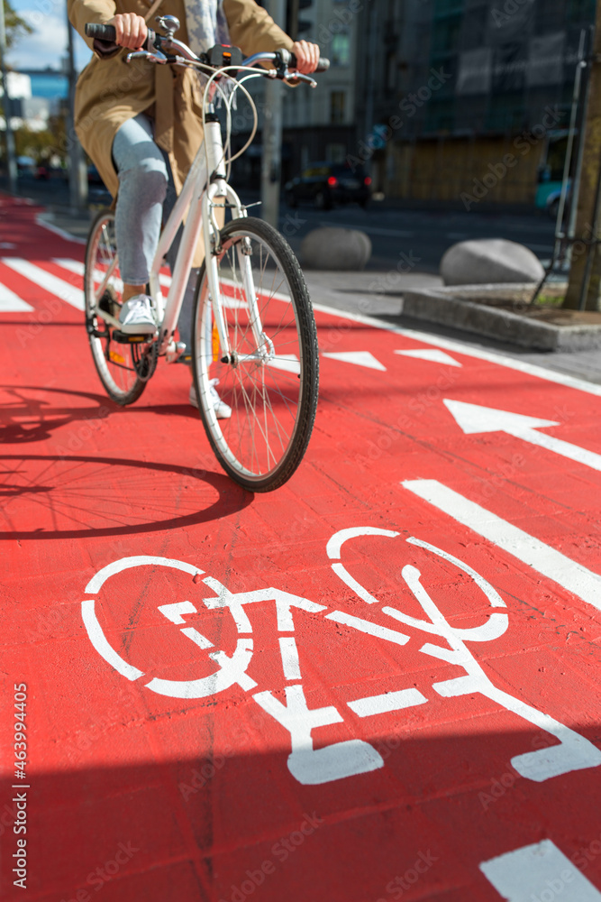 traffic, city transport and people concept - woman cycling along red ...