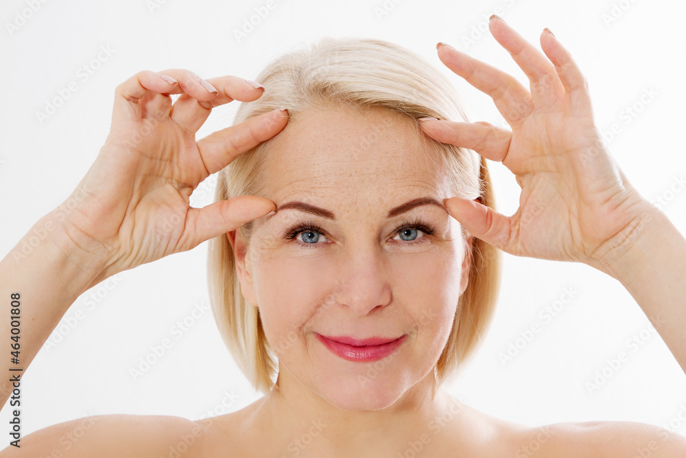 Macro Woman face with wrinkles on the forehead. Aging skin care and ...