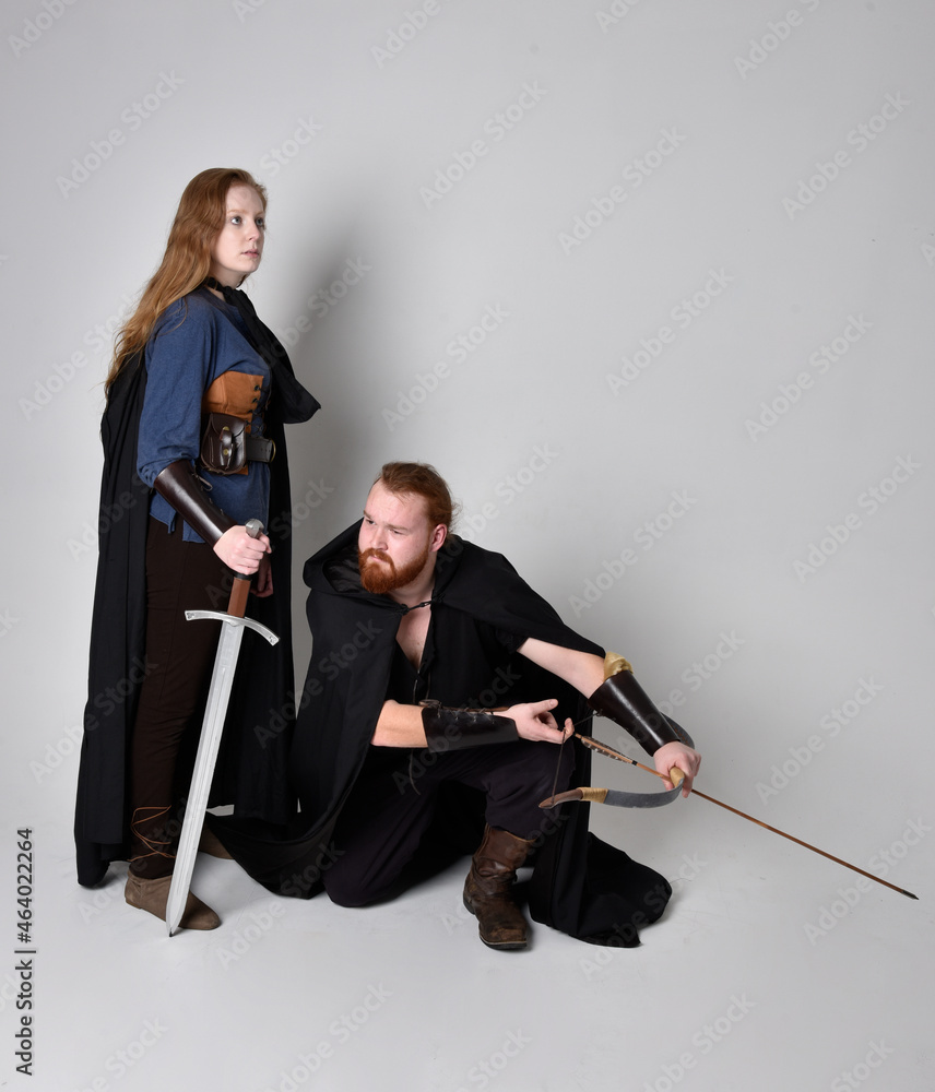 Full length portrait of red haired couple, man and woman wearing ...