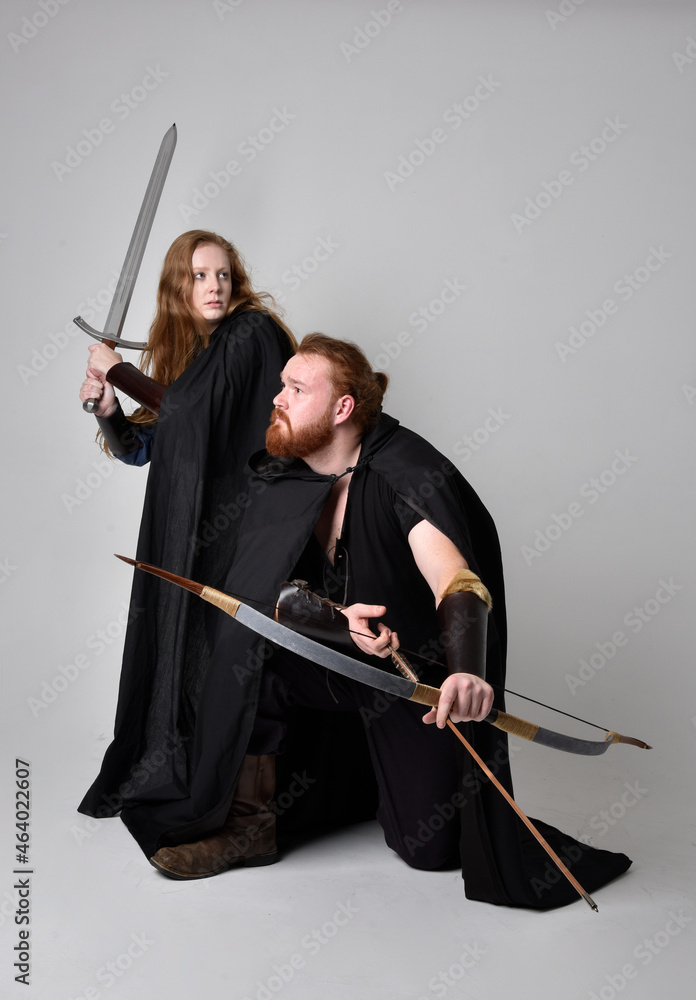 Full length portrait of red haired couple, man and woman wearing ...