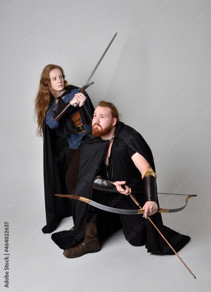 Full length portrait of red haired couple, man and woman wearing ...