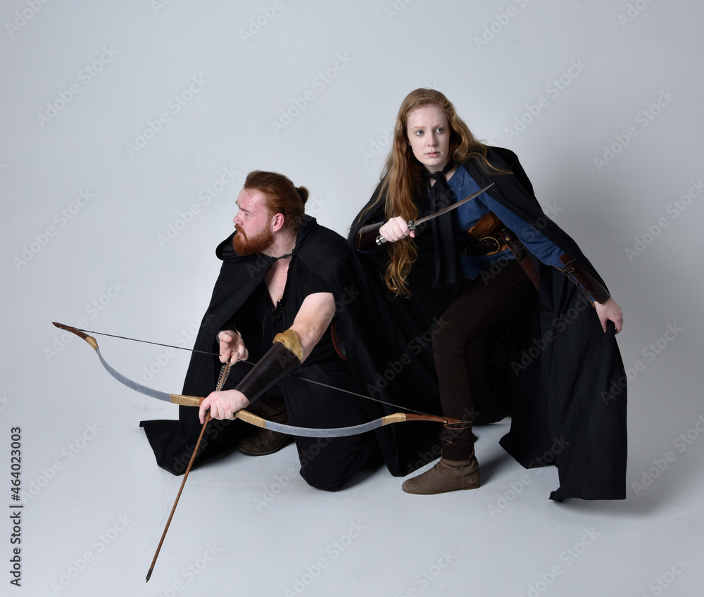 Full length portrait of red haired couple, man and woman wearing ...