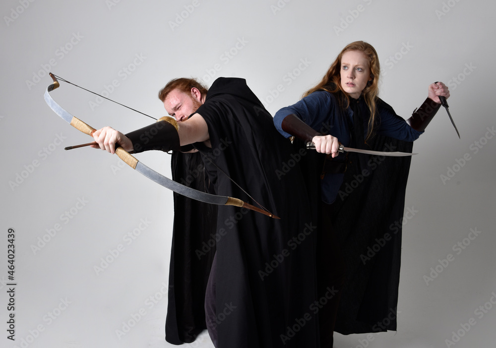Full length portrait of red haired couple, man and woman wearing ...