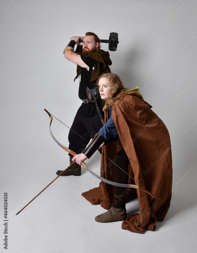 Full length portrait of red haired couple, man and woman wearing ...